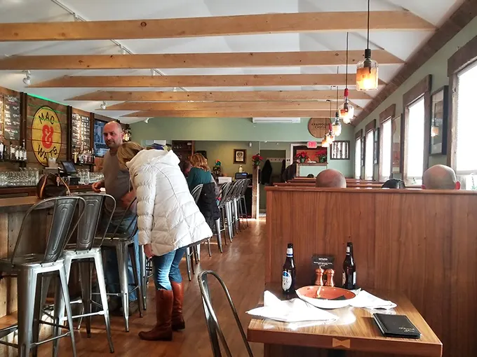 Inside, wooden beams and warm lighting create that perfect "where everybody knows your name" vibe—minus Norm, plus spectacular mac and cheese.