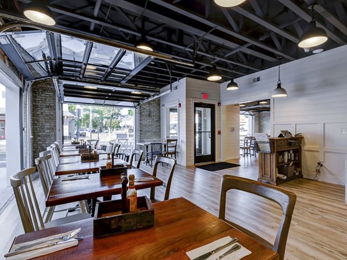 Industrial-chic meets cozy comfort inside, where garage-style windows blur the line between indoors and out. The perfect backdrop for the food drama about to unfold on your plate.
