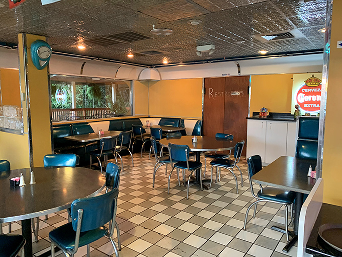 No-frills charm at its finest—checkered floors, blue vinyl chairs, and yellow walls create the perfect canvas for culinary masterpieces to shine.
