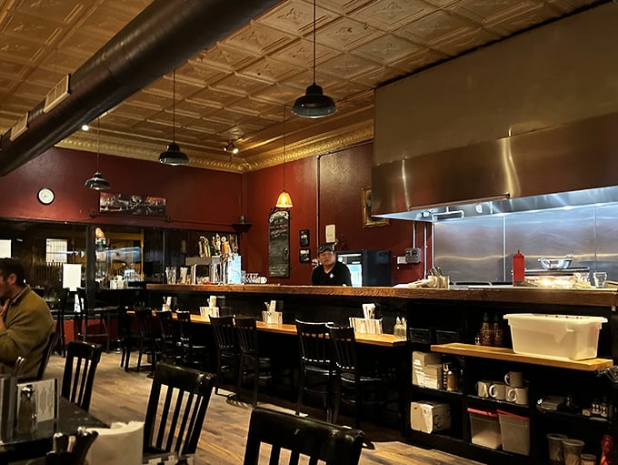 Step inside to find warm red walls, vintage tin ceilings, and the kind of cozy atmosphere that makes you want to linger over that last chip.