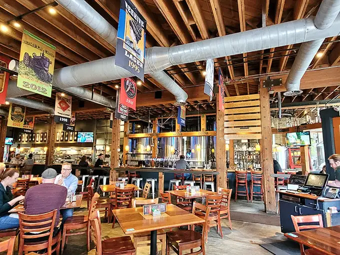 Step inside and the brewery reveals itself—exposed beams, hanging banners celebrating brewing triumphs, and that unmistakable buzz of happy diners.
