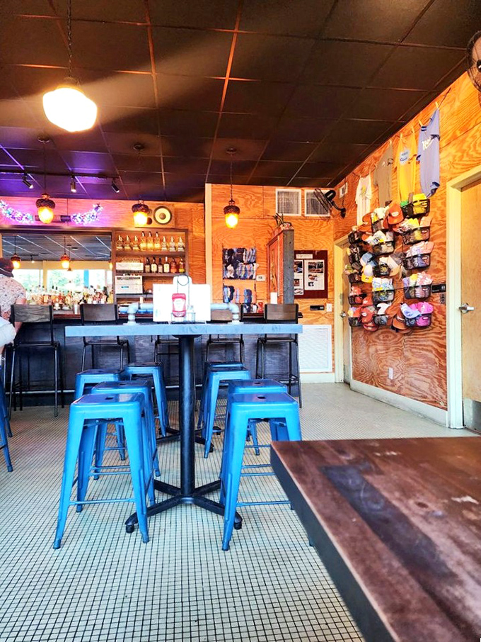 Industrial-chic meets comfort food haven. Those blue stools aren't just seating—they're front-row tickets to burger nirvana.