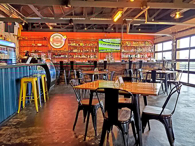 Inside, industrial chic meets bourbon country comfort—metal chairs, wooden tables, and a bar that would make any spirits enthusiast weak at the knees.