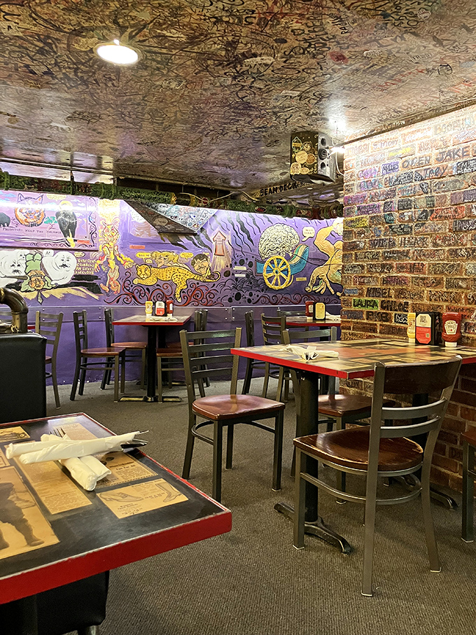 Where art meets appetite: The Sink's psychedelic murals and signature-covered ceiling create a dining experience that feeds your eyes and stomach simultaneously.