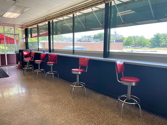 These classic red vinyl stools aren't trying to be retro-chic; they're the real deal, survivors from an era when "viral" meant catching a cold.