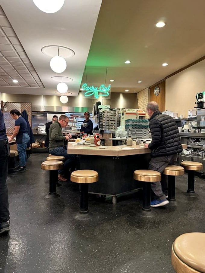 Counter culture at its finest – the heart of Lou Mitchell's where regulars perch on golden stools, trading stories over coffee that never stops flowing.