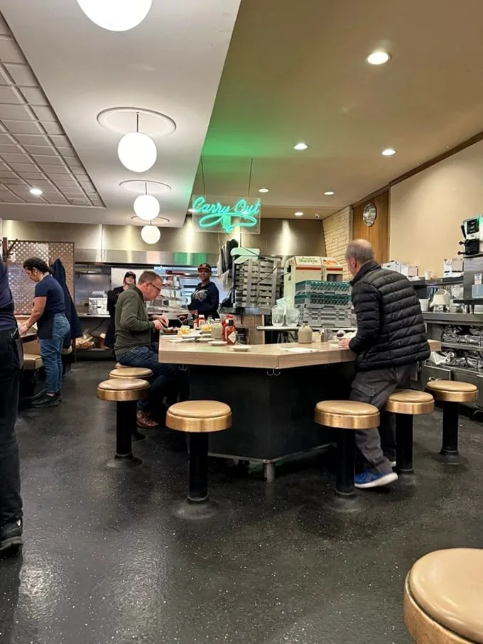 Counter culture at its finest – the heart of Lou Mitchell's where regulars perch on golden stools, trading stories over coffee that never stops flowing.