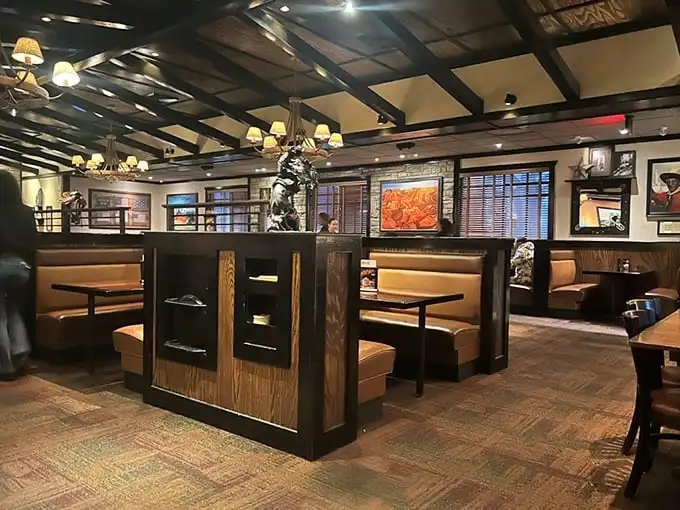 Warm wood tones, strategic lighting, and comfortable booths create that rare dining alchemy—a space that feels both spacious and intimate, like a Montana lodge teleported to Florida.