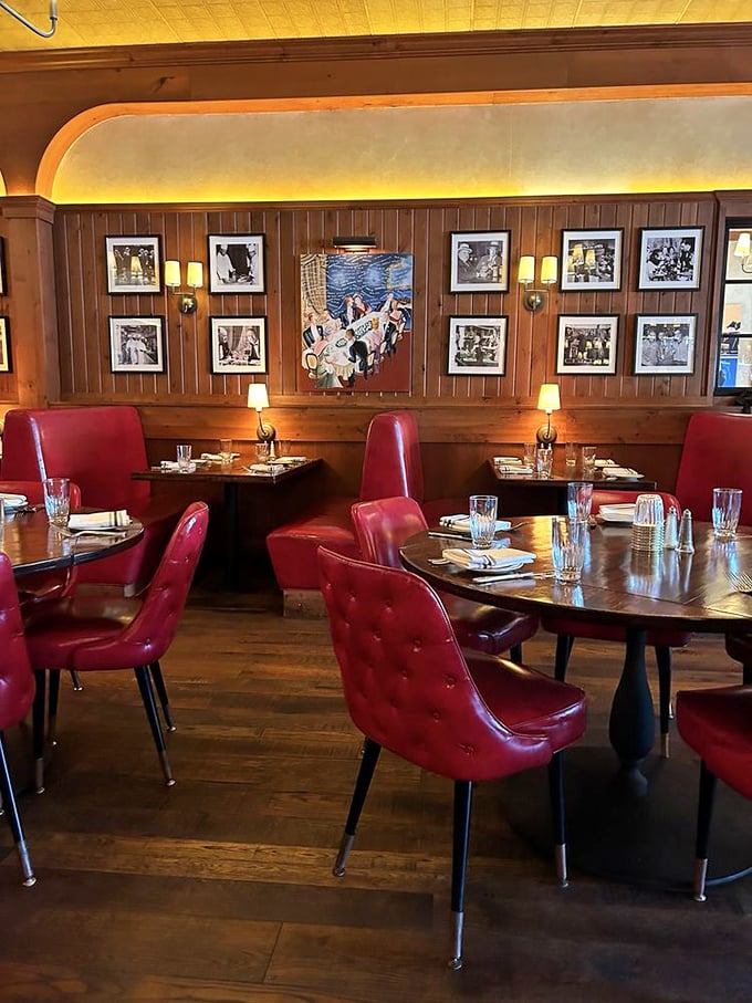 Mid-century modern meets classic steakhouse – those red leather chairs aren't just stylish, they're inviting you to settle in for the long haul.