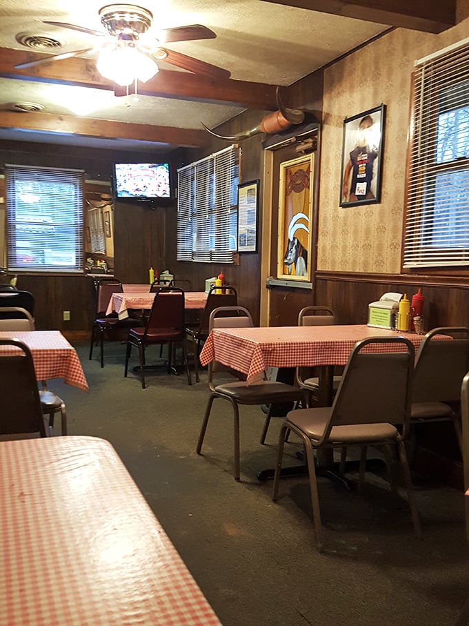 Classic red-checkered tablecloths and wood paneling create a time capsule of comfort where conversations flow as freely as the coffee refills.