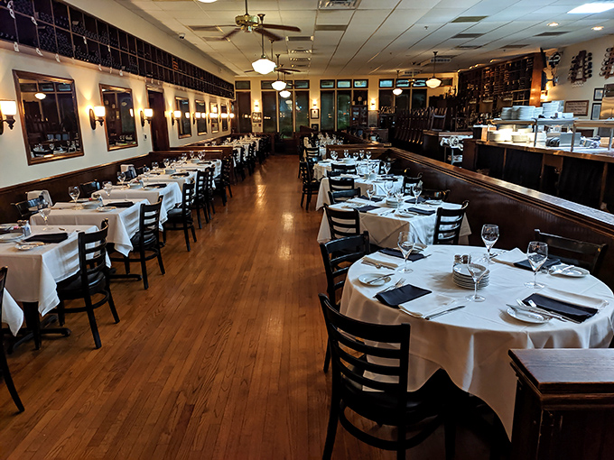 Classic steakhouse elegance meets Southern hospitality in this dining room where white tablecloths aren't just decorative—they're a canvas for culinary artistry.