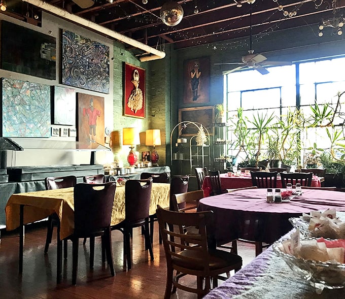 Step inside and discover a world where mismatched furniture, vibrant art, and hanging plants create the living room you wish you had.