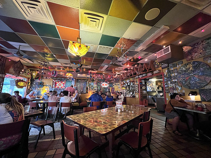 Dining under a patchwork sky of colorful ceiling tiles while surrounded by local art – Satchel's interior feels like falling into the creative side of Alice's wonderland.