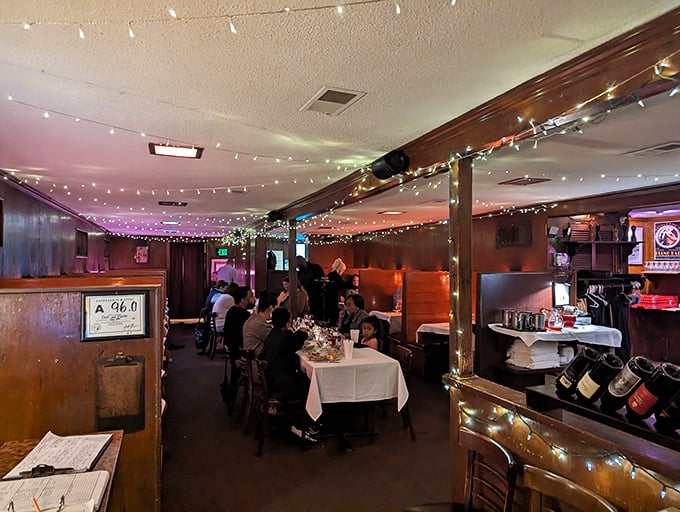 String lights dance overhead as diners settle into this wood-paneled sanctuary where time slows down and conversations deepen with each bite.