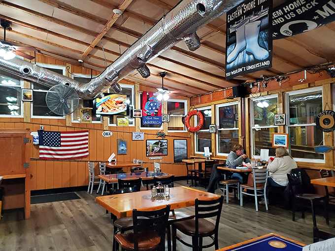 Wooden walls adorned with maritime memorabilia create the perfect backdrop for seafood feasting. This isn't designer decor—it's genuine coastal character.