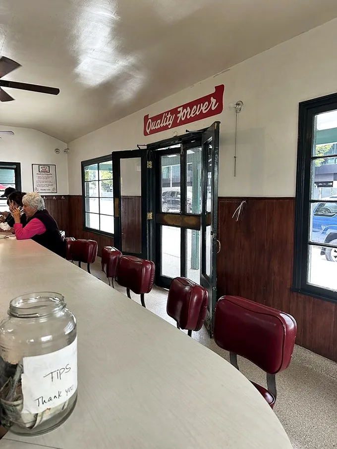 Red vinyl stools and a U-shaped counter – no tables, no booths, just the democratic simplicity of counter dining where everyone faces the action.