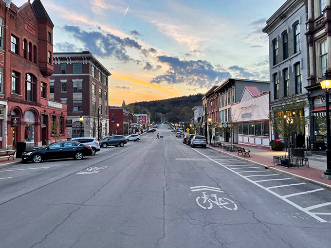 Main Street at dusk captures that magical moment when small-town charm meets urban possibility, with mountains framing the horizon like nature's own theater backdrop. 