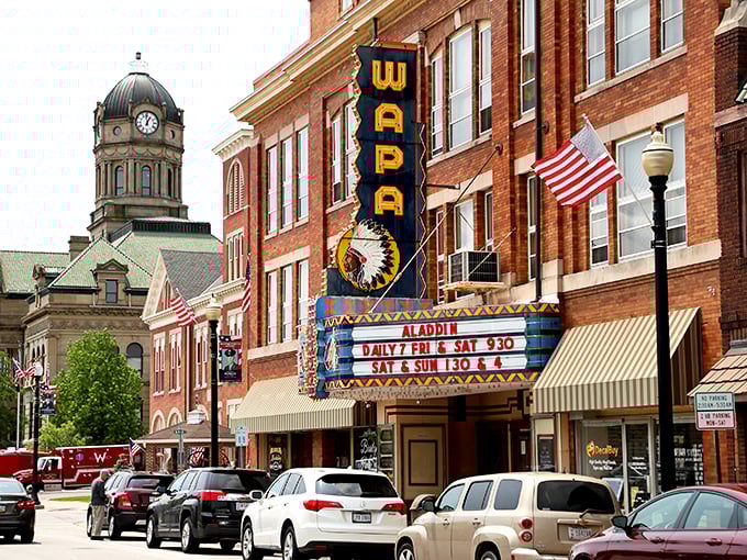 The historic Wapa Theatre marquee glows against the courthouse backdrop, a perfect small-town tableau that Norman Rockwell would've painted in a heartbeat.