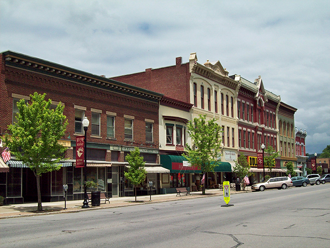 Main Street's colorful facades create a living timeline of American small-town evolution. Those trees aren't just decoration—they're nature's way of high-fiving good architecture.