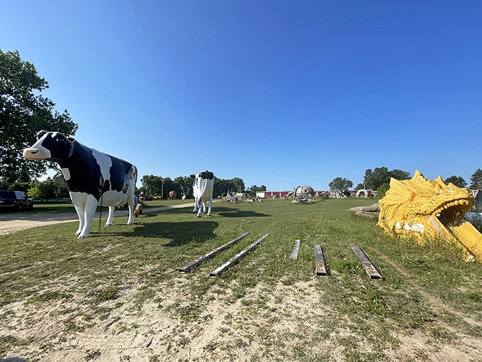 Talk about an unusual family reunion! Holstein cows and a golden dragon coexist peacefully in this bizarre pastoral scene, where roadside America dreams retire.
