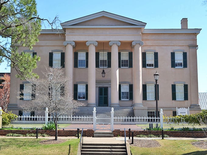 The Old Governor's Mansion stands as a testament to Greek Revival grandeur, its columns reaching skyward like architectural exclamation points declaring "History happened here!"