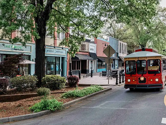 The charming red trolley isn't just for tourists—it's Milledgeville's nod to its historical significance, rolling through streets where modern shops inhabit centuries-old buildings.