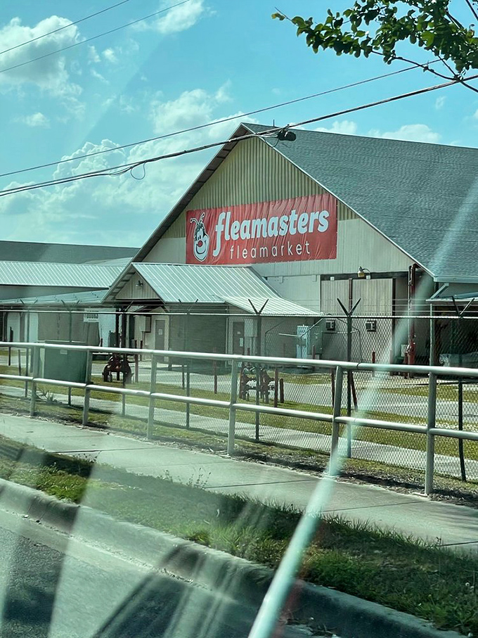 The unassuming exterior with its iconic red sign serves as a portal to a wonderland of finds—like the wardrobe to Narnia, but with better souvenir options.