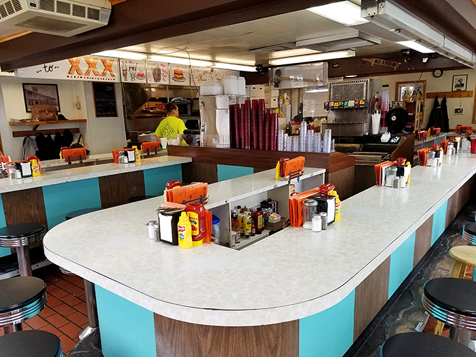 The horseshoe counter isn't just seating—it's theater-in-the-round where diners become part of a decades-old culinary performance art.