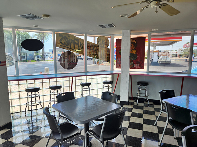 Classic black and white checkered floors set the stage for burger magic. This isn't décor – it's a time machine to when dining was straightforward.