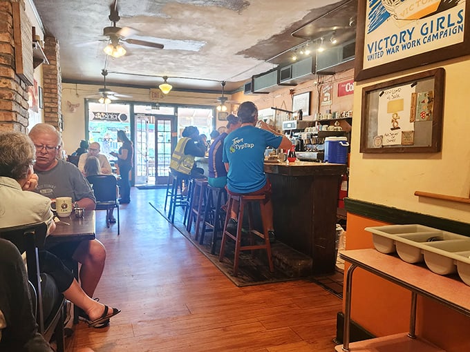 Inside, the cozy dining room feels like breakfast's natural habitat—worn wooden floors, vintage posters, and regulars perched at the counter like they own the place.
