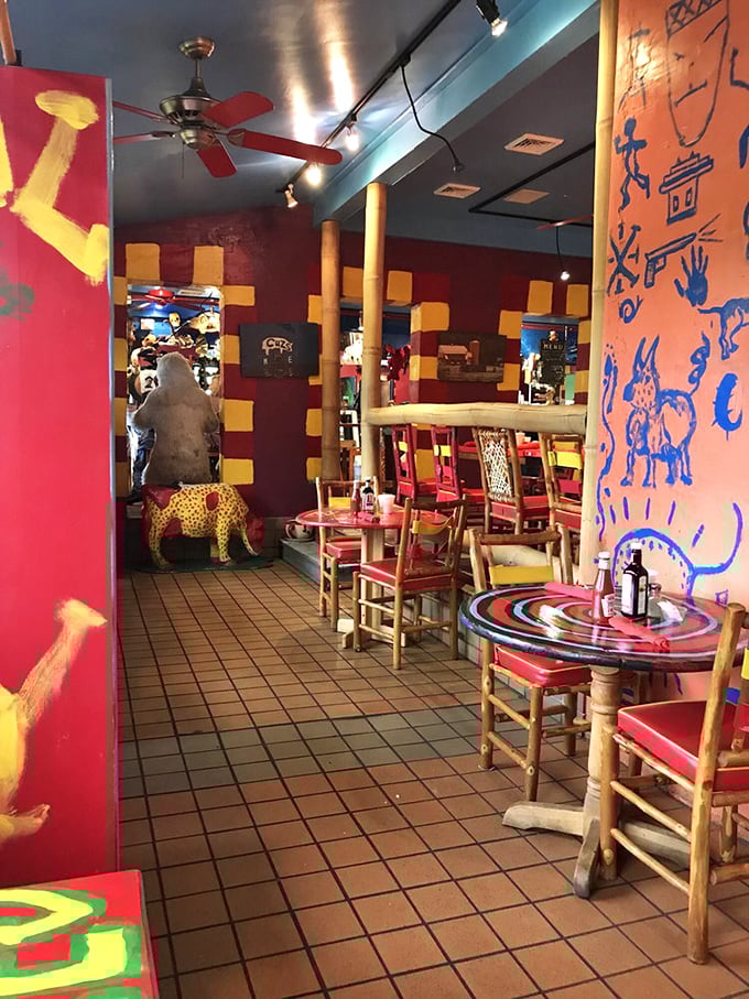 Step inside and prepare for sensory whiplash – vibrant folk art walls, wooden log columns, and colorful furniture create a dining space that's equal parts mountain lodge and modern art gallery.