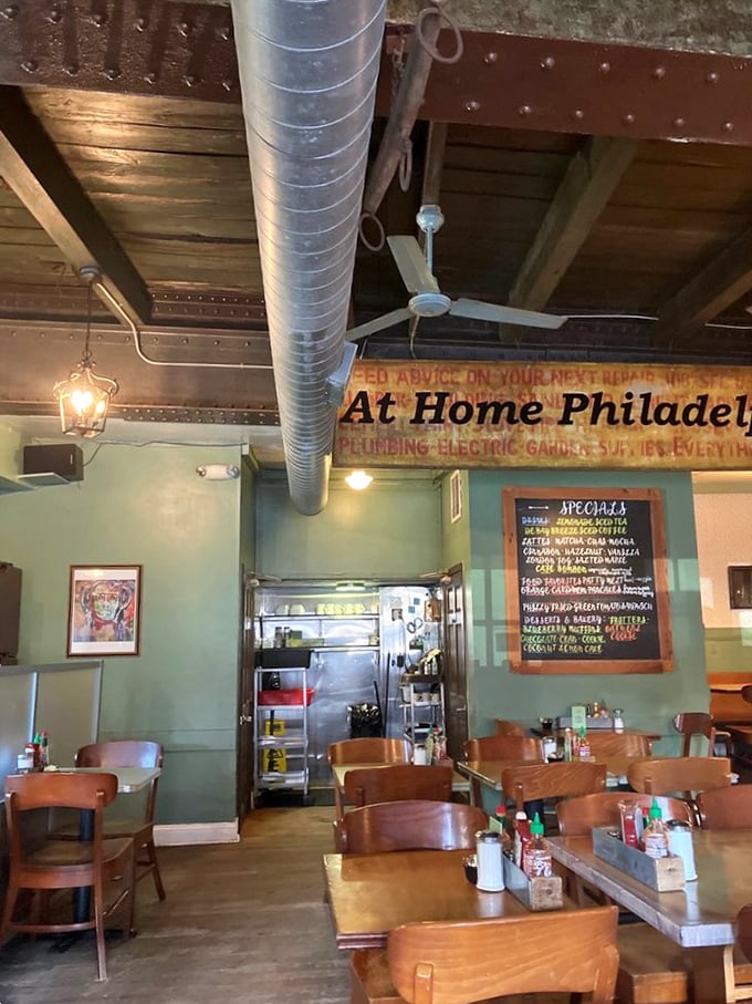 Industrial meets homey with mint green walls and exposed ductwork. The vintage "At Home Philadelphia" sign isn't lying—you'll want to move in permanently.