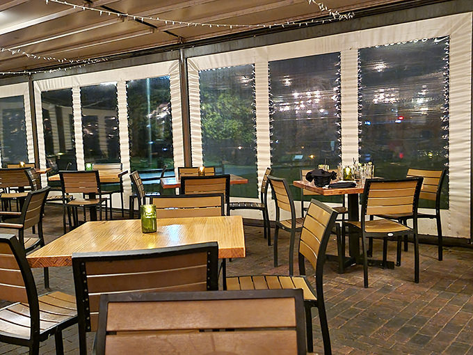Twinkling lights and river views transform this enclosed porch into dining magic – Mother Nature's dinner theater at its finest.
