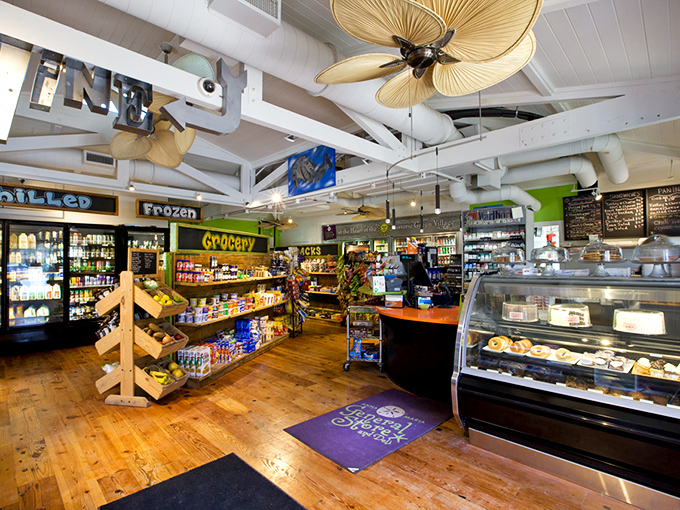 Tropical ceiling fans lazily stir the air while wooden shelves burst with provisions. This isn't just grocery shopping – it's a treasure hunt with delicious rewards.