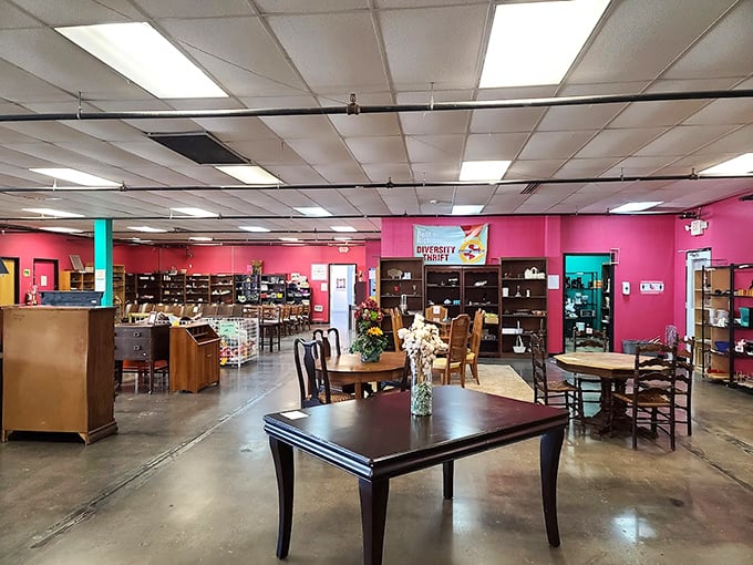 Hot pink walls frame an eclectic furniture showroom where dining sets await their second act. Every piece tells a story—some more colorful than others.