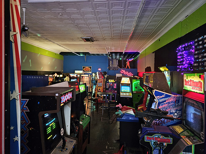 Neon dreams and digital screams—this corridor of cabinets holds more childhood memories than your parents' attic, with twice the blinking lights.