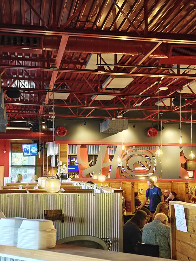 Industrial meets rustic with those striking red ceiling beams—creating the perfect backdrop for serious eating and not-so-serious conversation.