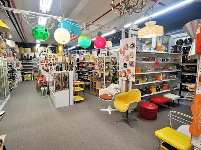 Colorful vintage globe lights hang like jewels above mid-century chairs, creating a retro playground where every aisle promises new discoveries.