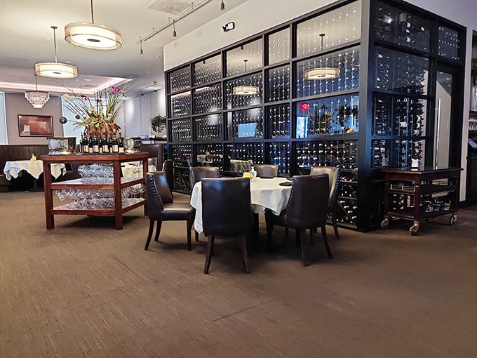 Wine bottles stand at attention behind glass like soldiers guarding liquid treasures, while diners plot their next delicious move.