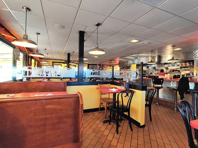Classic wooden booths and counter seating create that perfect diner atmosphere where memories are made and pancakes disappear.