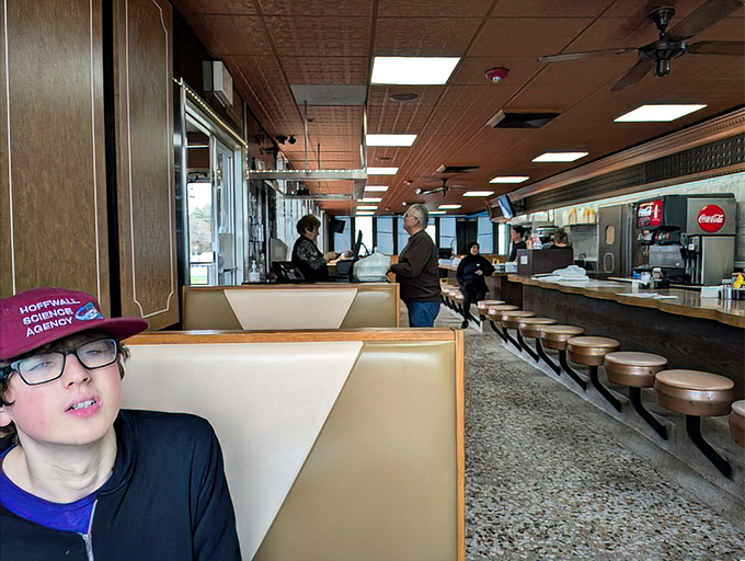 Inside, the counter ballet unfolds—swiveling stools await solo diners while servers navigate the narrow passage with the grace of seasoned performers. 