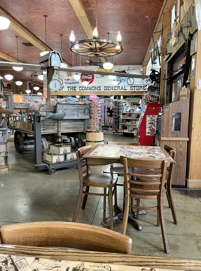 Wagon wheel chandelier, wooden tables, and treasures waiting to be discovered. This isn't décor—it's a living museum where the exhibits can actually go home with you.
