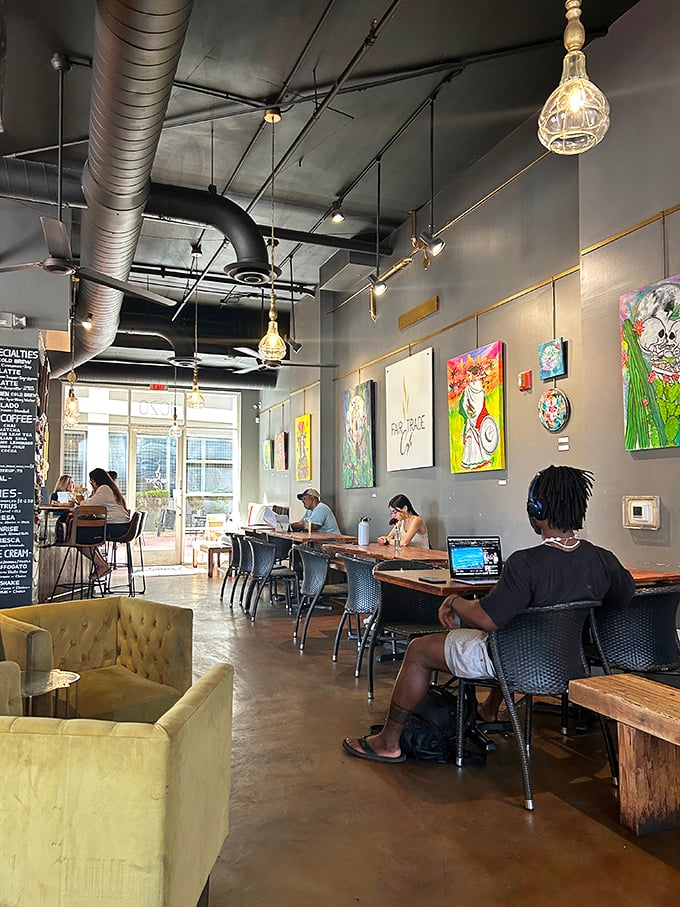 Inside, industrial-chic meets creative workspace—where laptop warriors and conversation enthusiasts find common ground under exposed ductwork and local art.