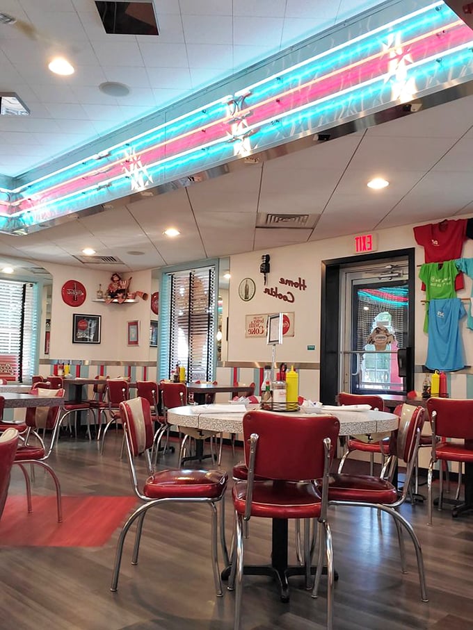 Step inside and the decades melt away—neon lights, chrome accents, and those iconic red vinyl chairs transport you to an era when Elvis was king and milkshakes ruled.
