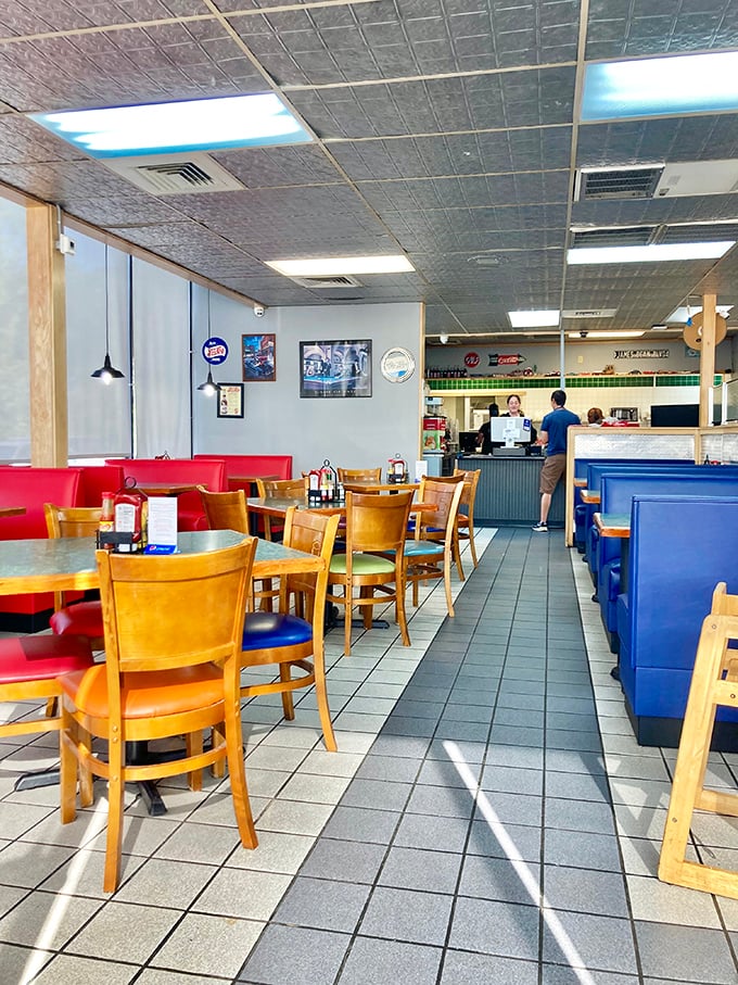 Classic diner geometry: red booths, blue banquettes, and wooden chairs create the perfect equation for relaxation. The formula for happiness includes coffee.