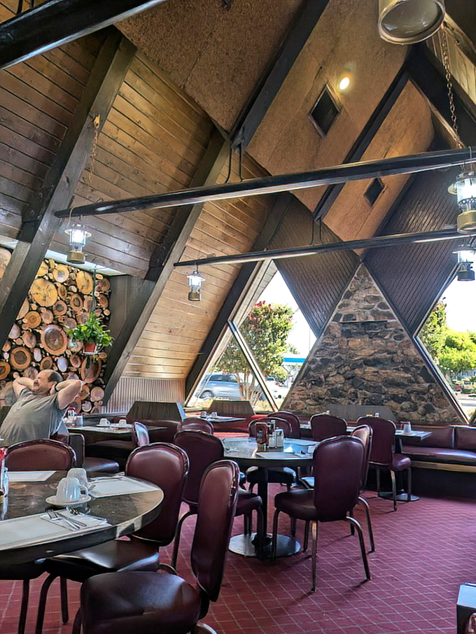 Step inside and the A-frame ceiling with wooden beams creates a cozy cabin vibe – like breakfast in a mountain retreat, minus the long drive.