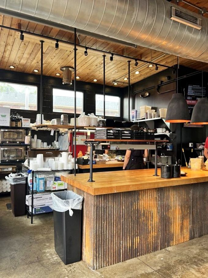 Inside Ray Ray's, function meets flavor with a rustic industrial vibe—wooden ceilings, corrugated metal, and the promise of barbecue magic.