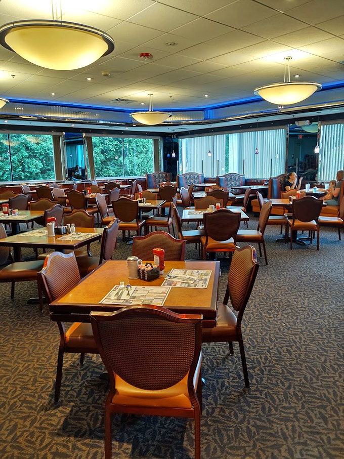 Inside, the blue-accented lighting casts a comforting glow over wood tables and patterned carpet – diner perfection that says "stay awhile."