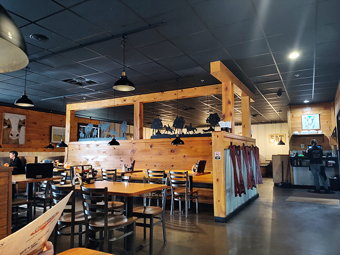 Warm wooden paneling and thoughtful dividers create intimate dining spaces without sacrificing the communal energy that makes steakhouses special.
