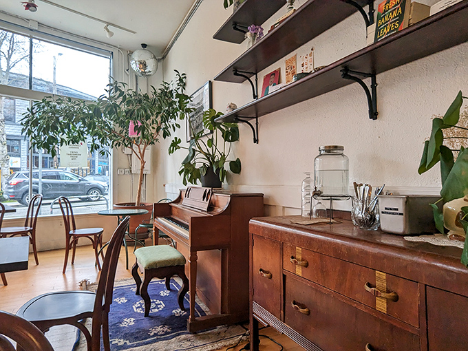 A piano in the corner, lush plants by the window—this isn't just a café, it's someone's impossibly stylish living room that happens to serve incredible food.
